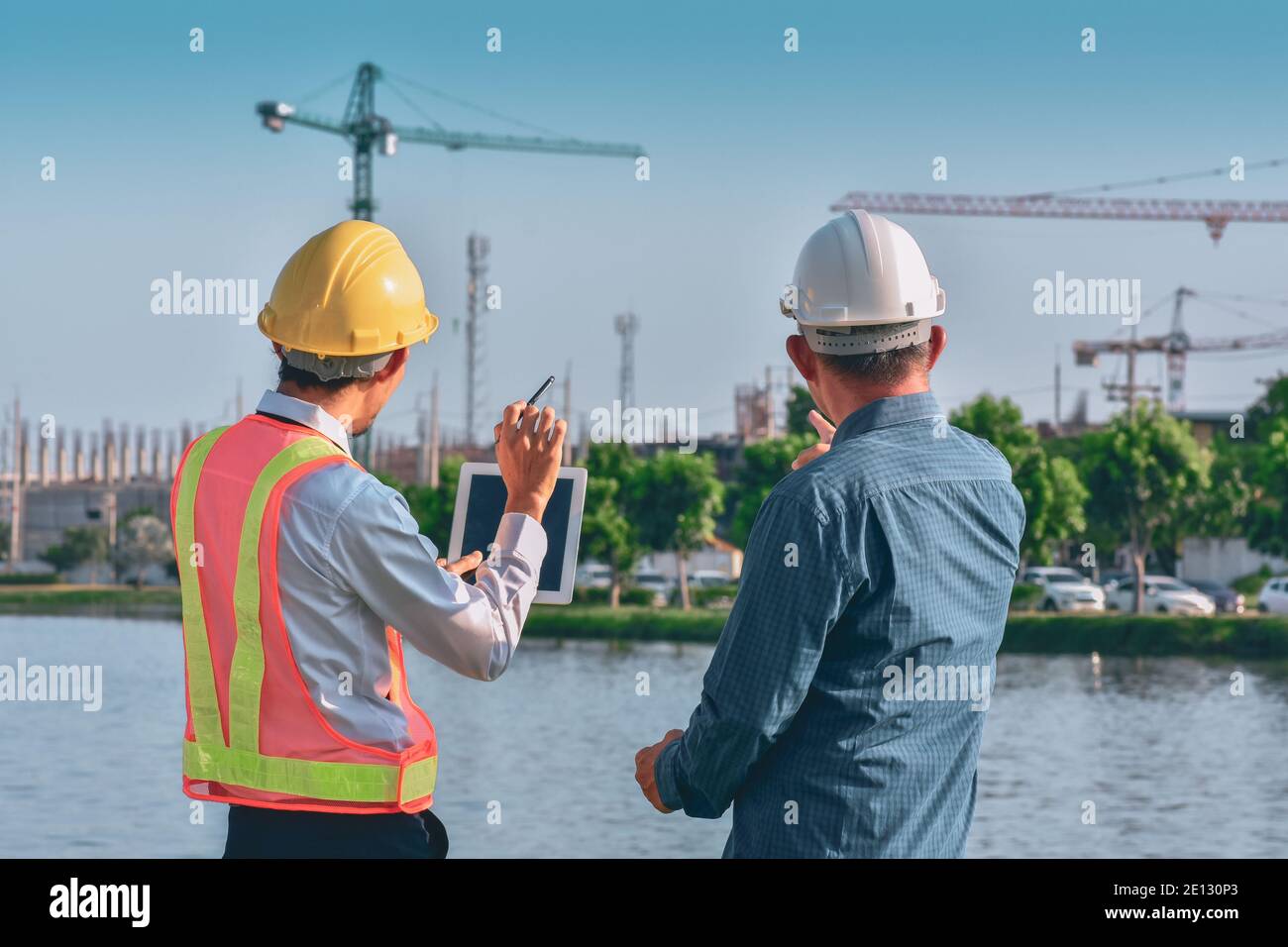 Two people worker Engineer talking discussion by tablet on site ...