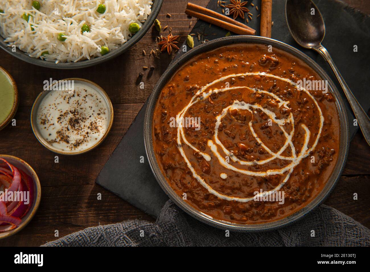 Dal Makhni with rice and raita (curd) and onion rings Stock Photo - Alamy