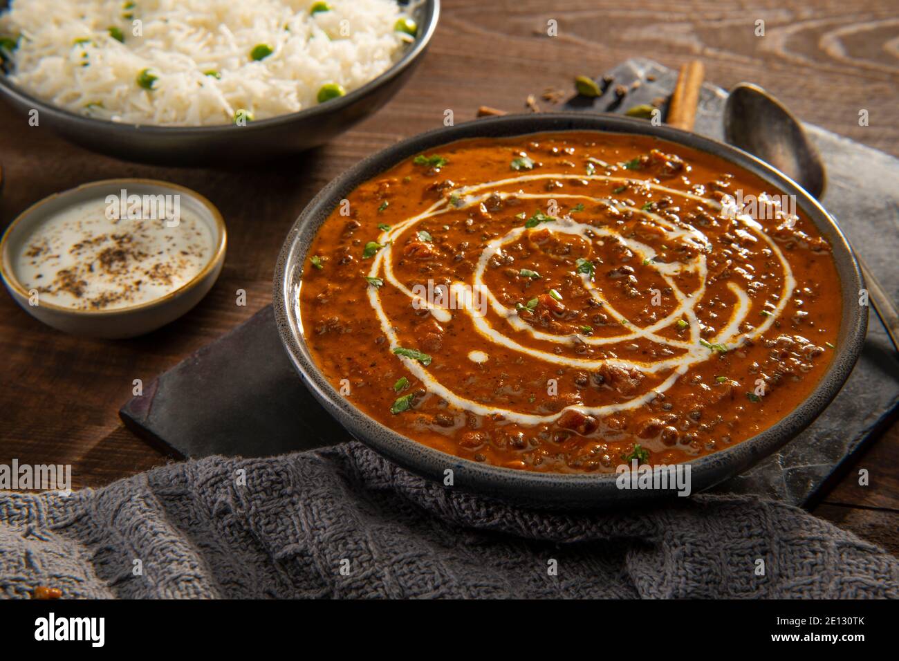 Dal Makhni with rice and raita (curd) and onion rings Stock Photo - Alamy