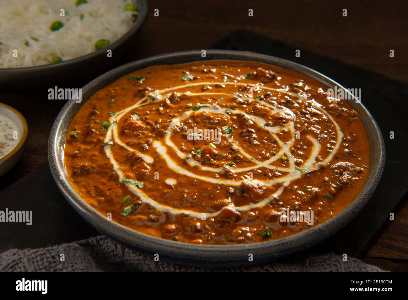 Dal Makhni with rice and raita (curd) and onion rings Stock Photo - Alamy