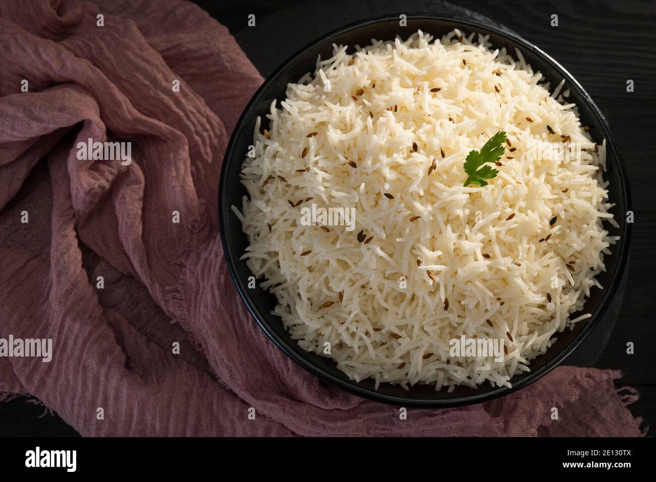 Steamed rice with Cumin in a black bowl Stock Photo - Alamy