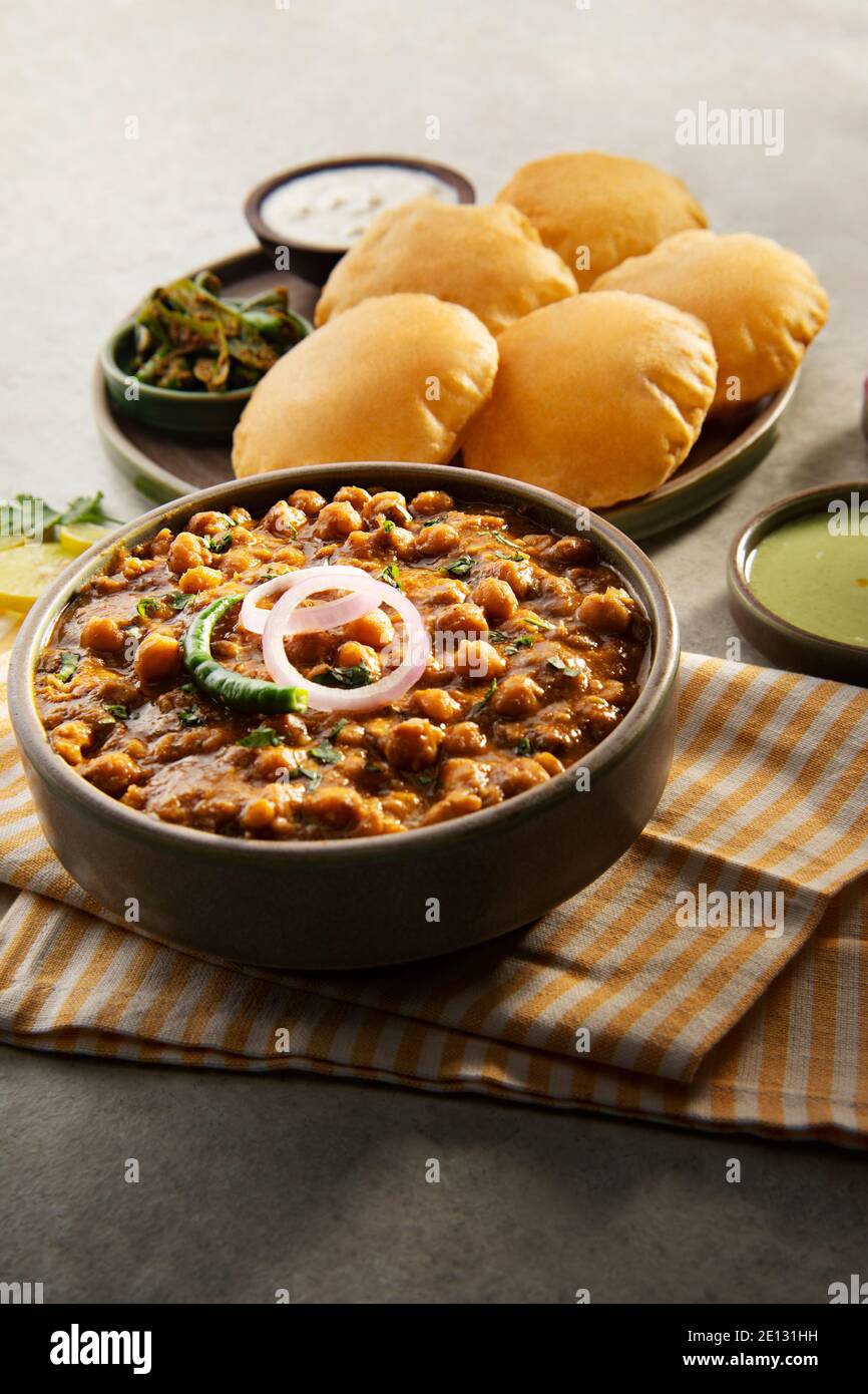 GARNISHED CHOLE CURRY SERVED HOT WITH PURIS AND PICKLE Stock Photo - Alamy
