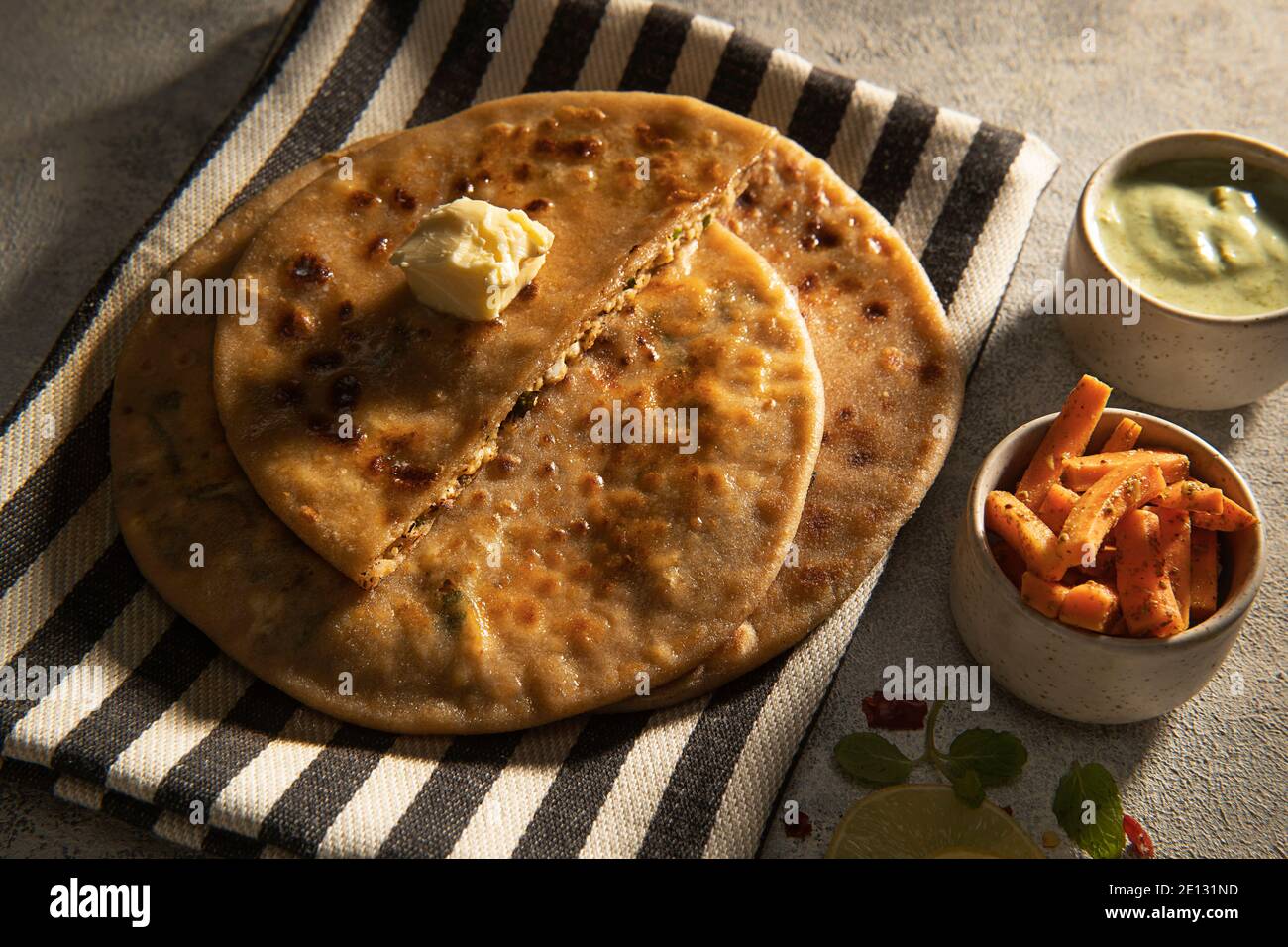 STUFFED PARATHAS WITH BUTTER TOPPING SERVED WITH PICKLE AND CHUTNEY ...