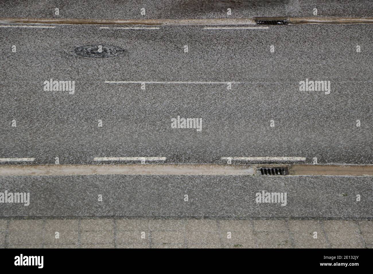 Small hailstone covering on a road creating dangerous driving ...