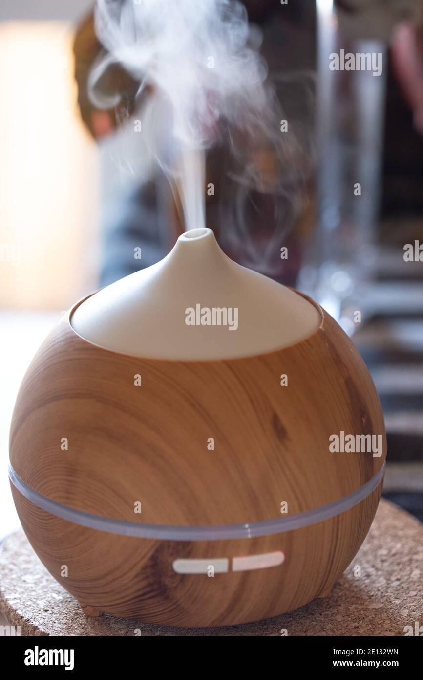 Aroma oil diffuser lamp on a table. Aromatherapy and health care ...