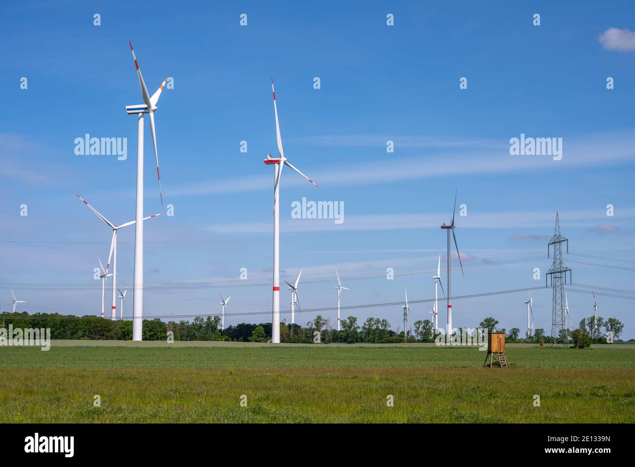 Modern windmills and a power line in Germany Stock Photo - Alamy