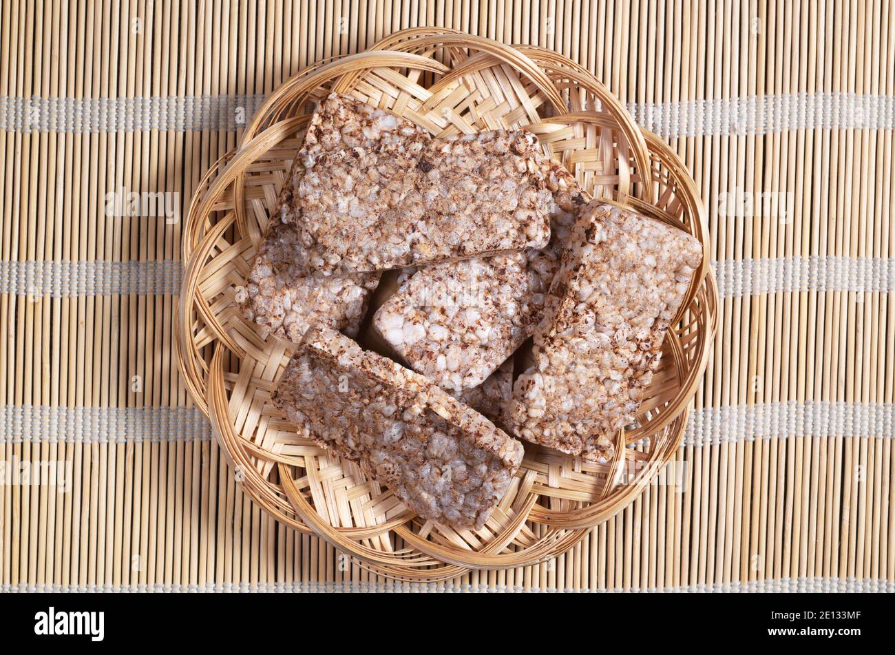 Buckwheat crisp bread in wicker plate on bamboo napkin, top view ...