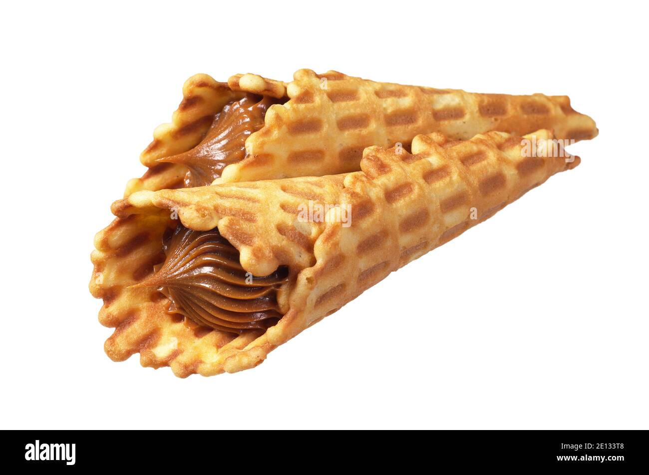 Two waffles cones with condensed milk isolated on white background ...