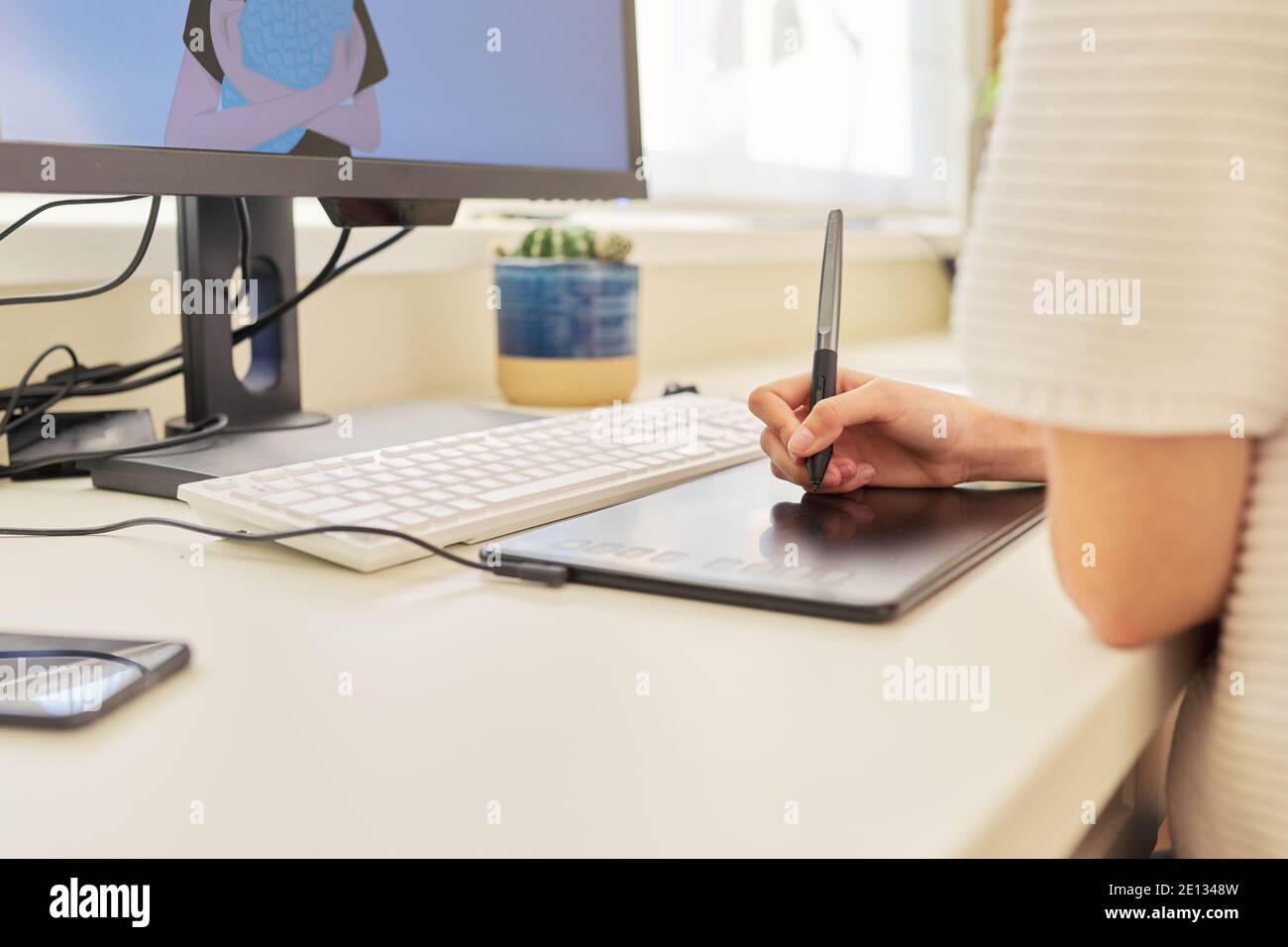 Close-up of young woman's hand drawing on computer using graphics ...