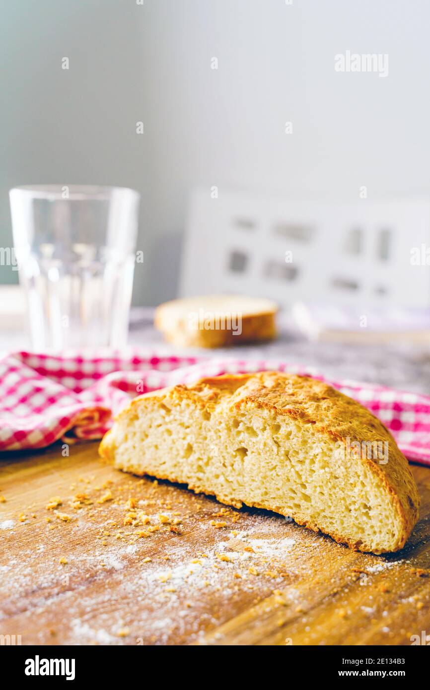 Fresh homemade baked bread on the table at home ready to eat copy space ...