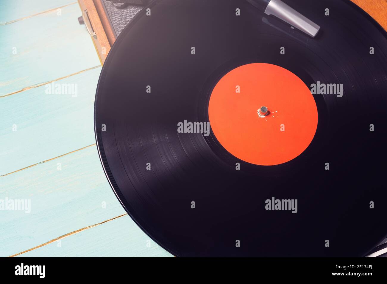 Old gramophone with a vinyl record on green wooden table, top view ...