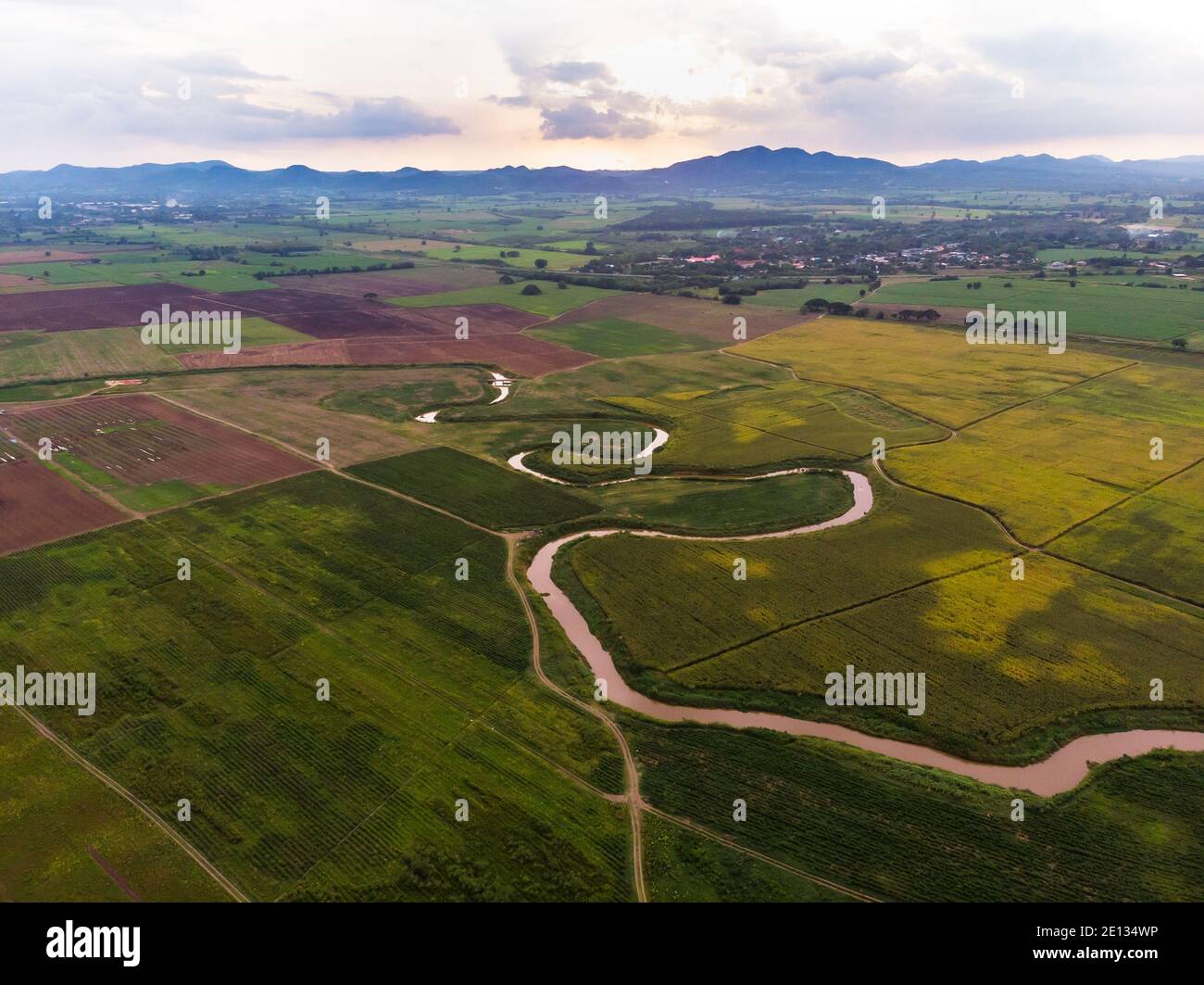 Scenic landscape aerial view of field river and basin against a natural ...