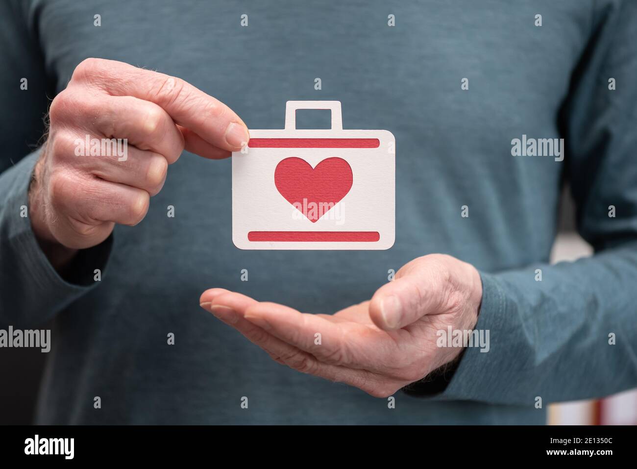 Man holding a paper medical briefcase; Symbol of health insurance Stock ...