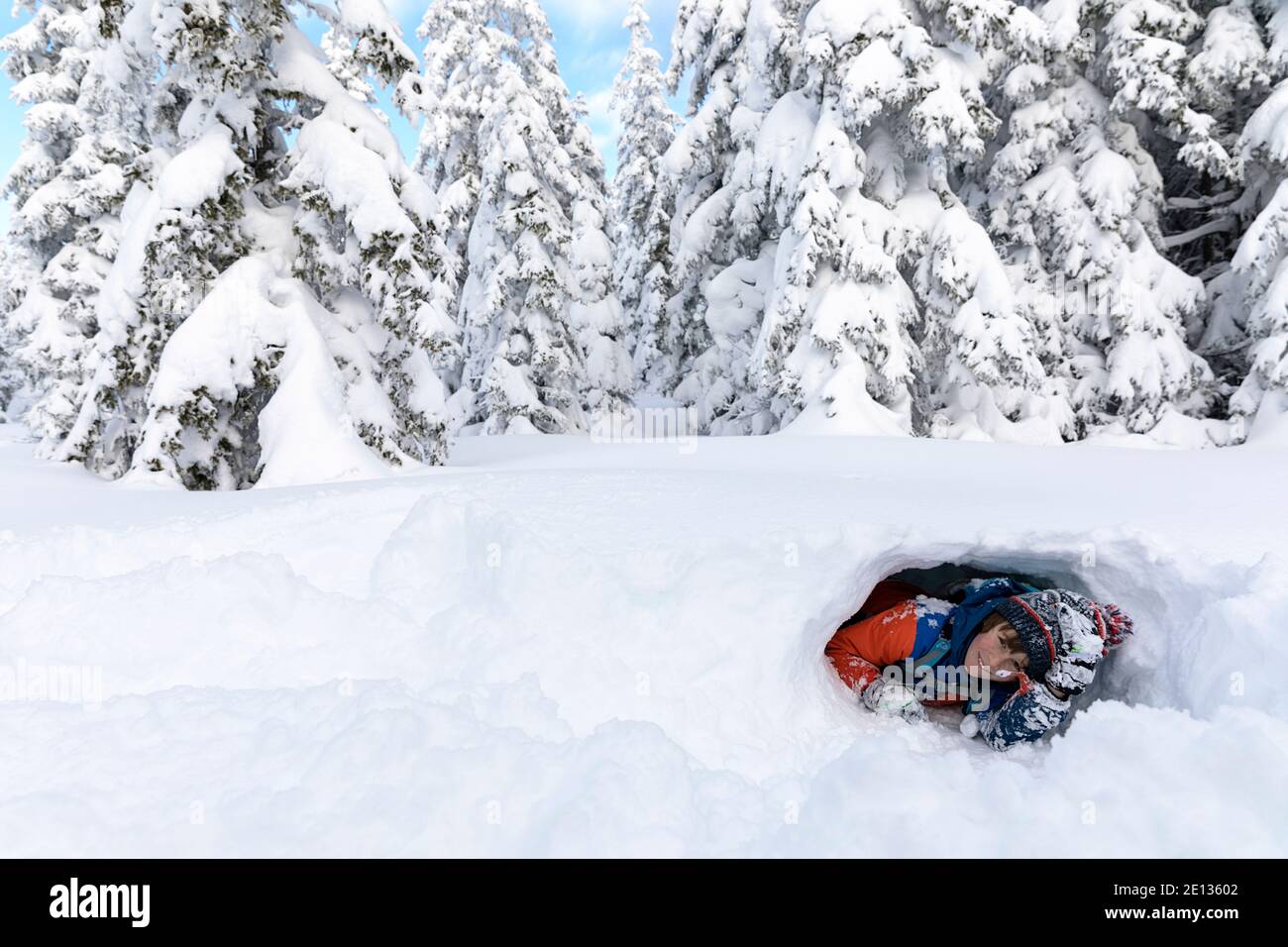 boy laying in igloo he made Stock Photo - Alamy