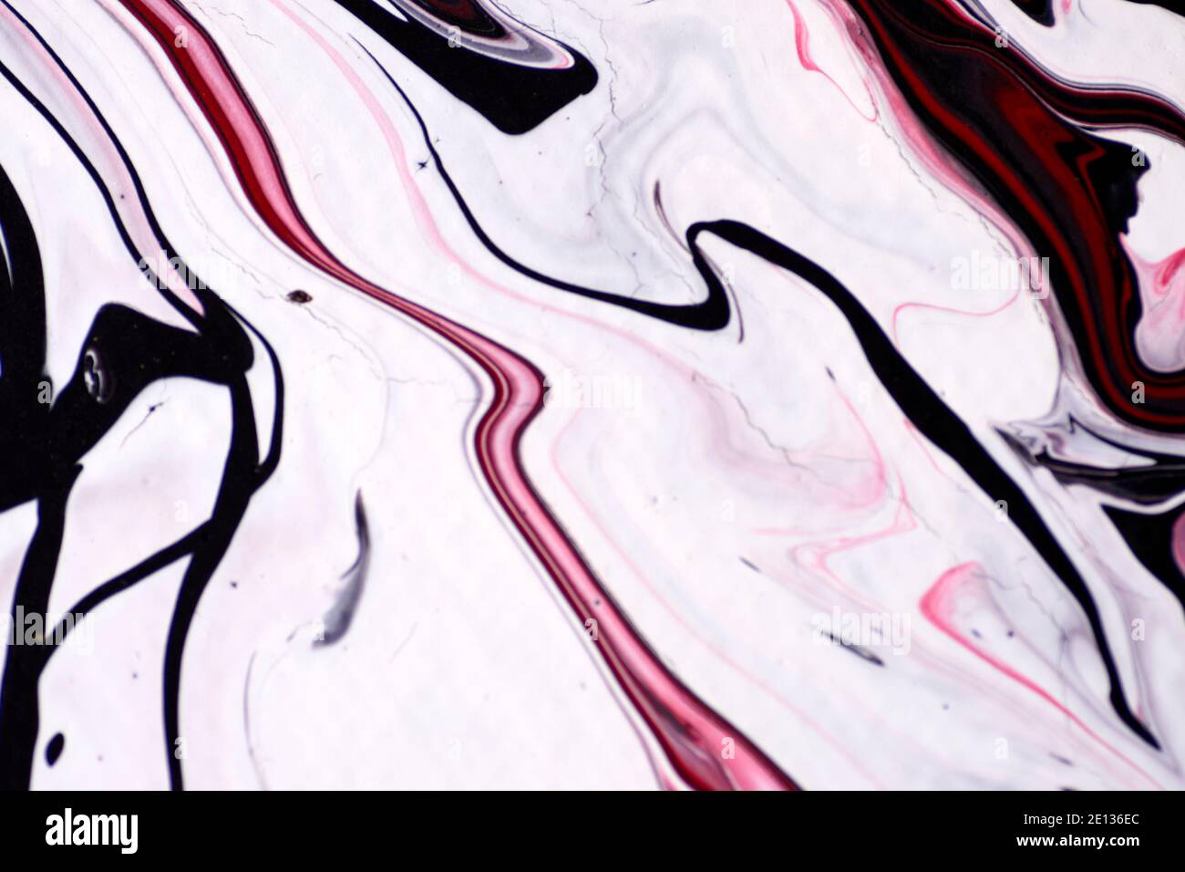 Marbled acrylic colored pattern in the colors red, black, white and ...