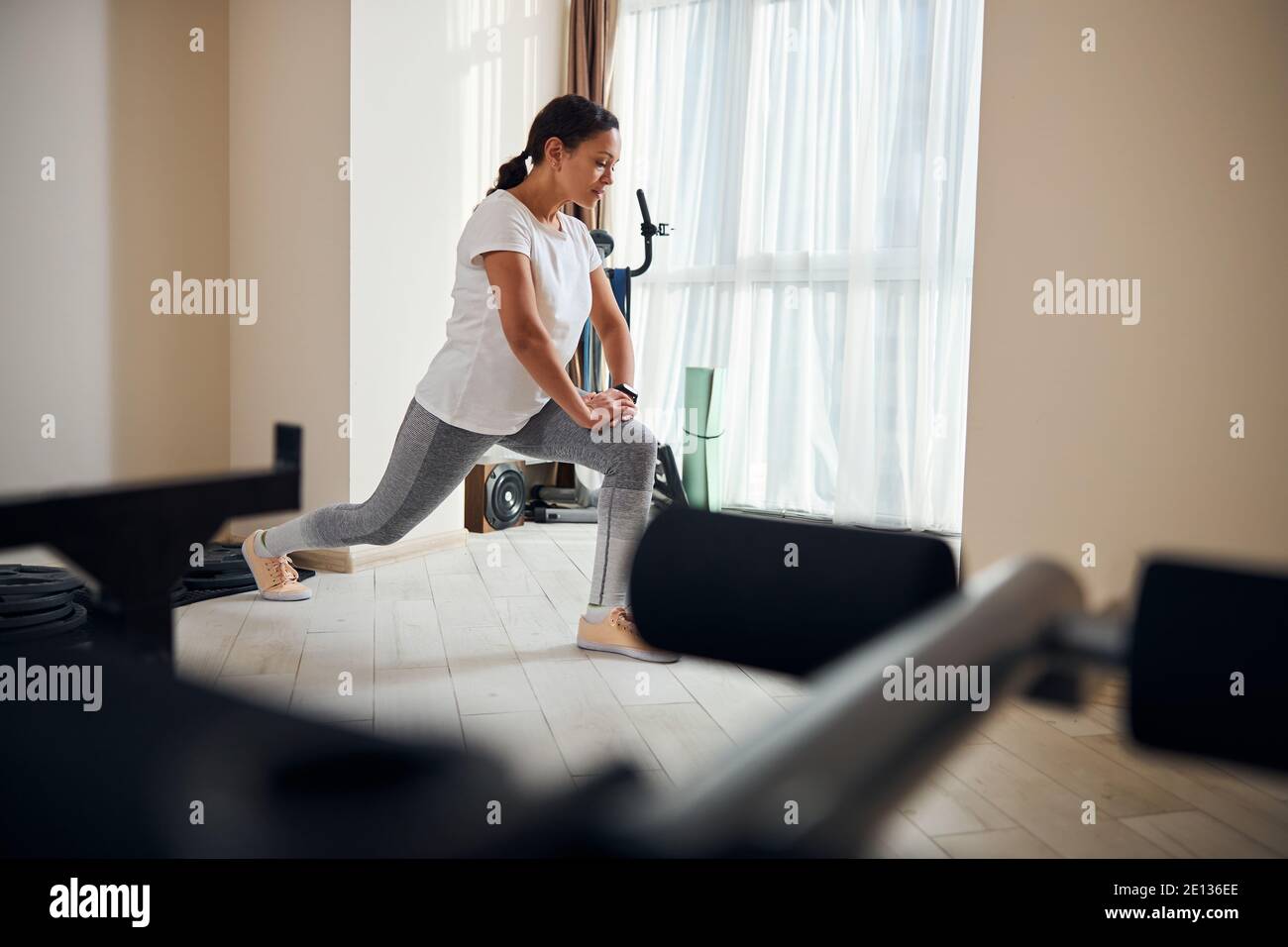 Professional female athlete performing a stretching exercise Stock ...
