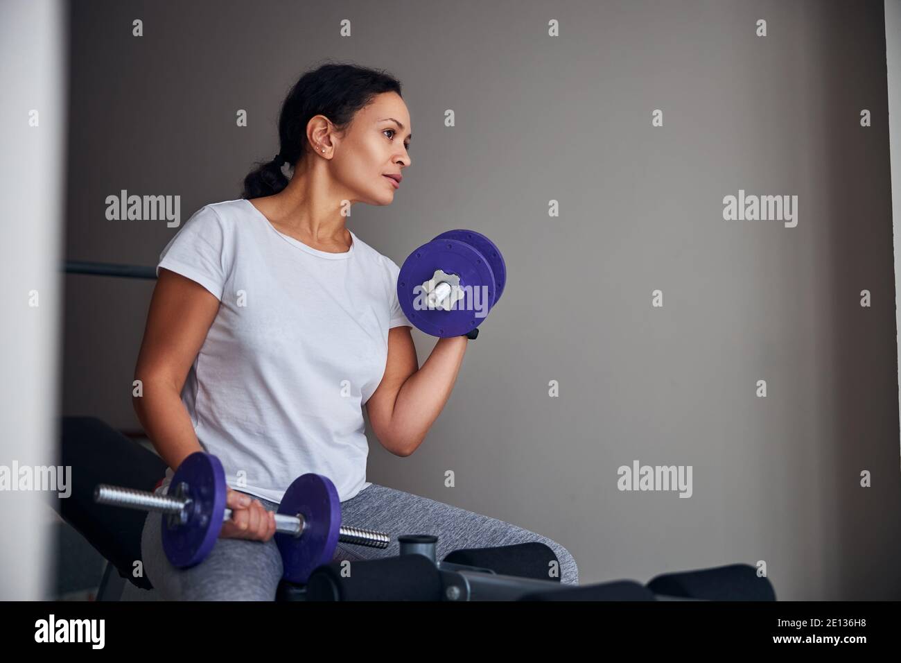 Professional female bodybuilder performing a strength exercise Stock ...