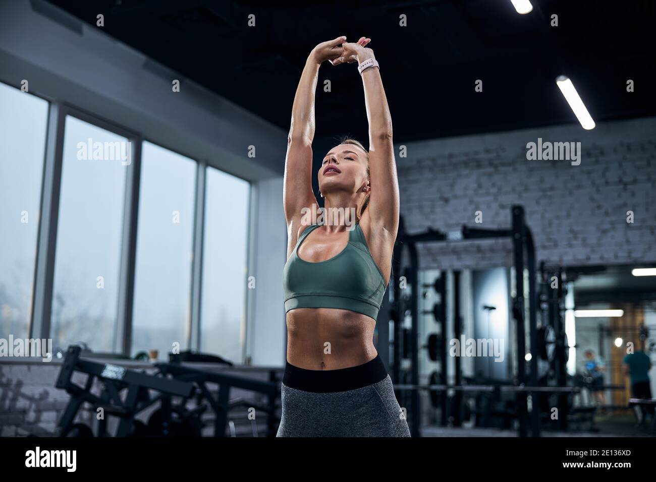 Female raising her arms in a gym Stock Photo - Alamy