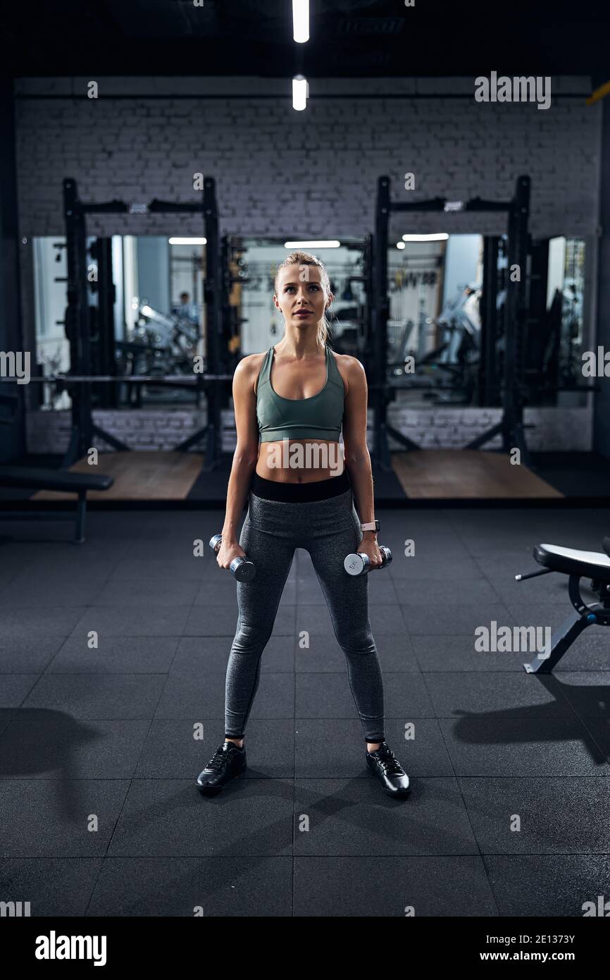 Woman carrying dumbbells hi-res stock photography and images - Alamy
