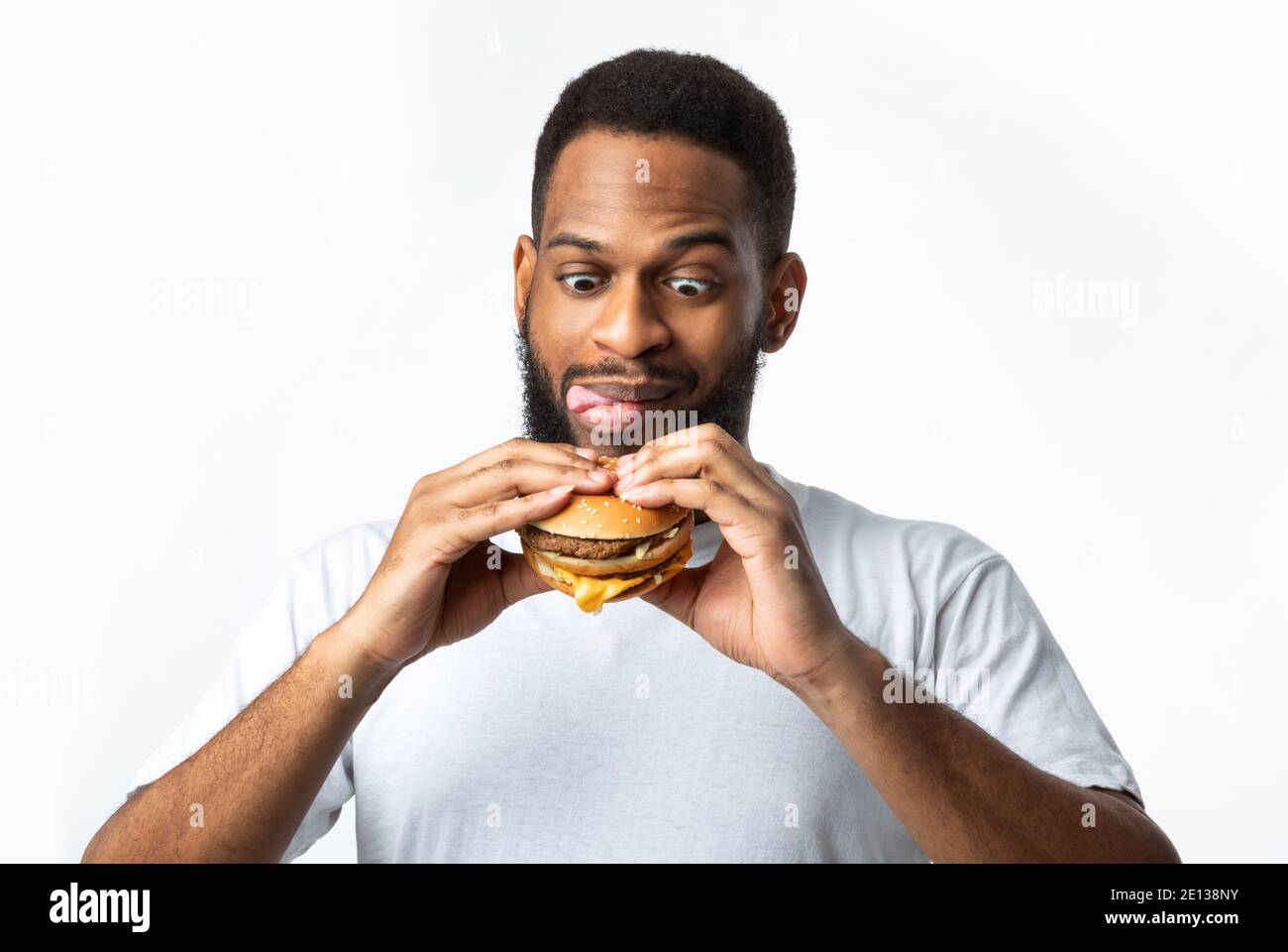 Hungry Black Man Holding Tasty Burger Standing On White Background ...