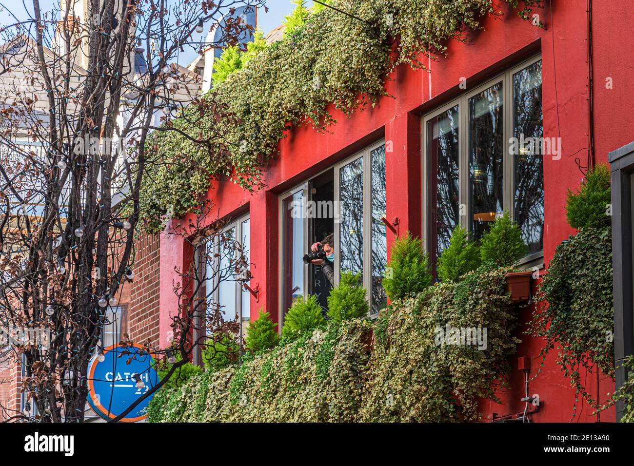 Photographer with DSLR camera taking some shots from the window. Dublin ...