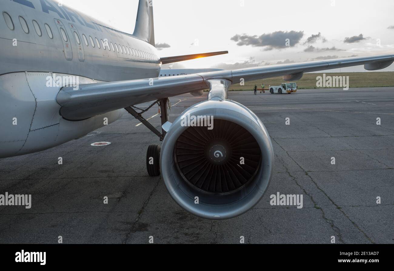 The wing and engine of the plane in the light of the setting sun Stock ...