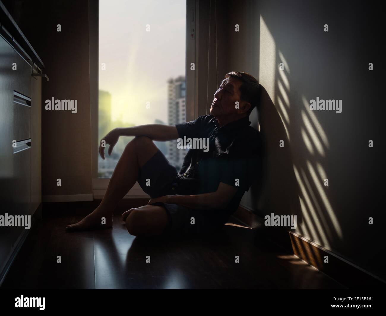 Senior asian man sitting alone in the apartment Stock Photo - Alamy
