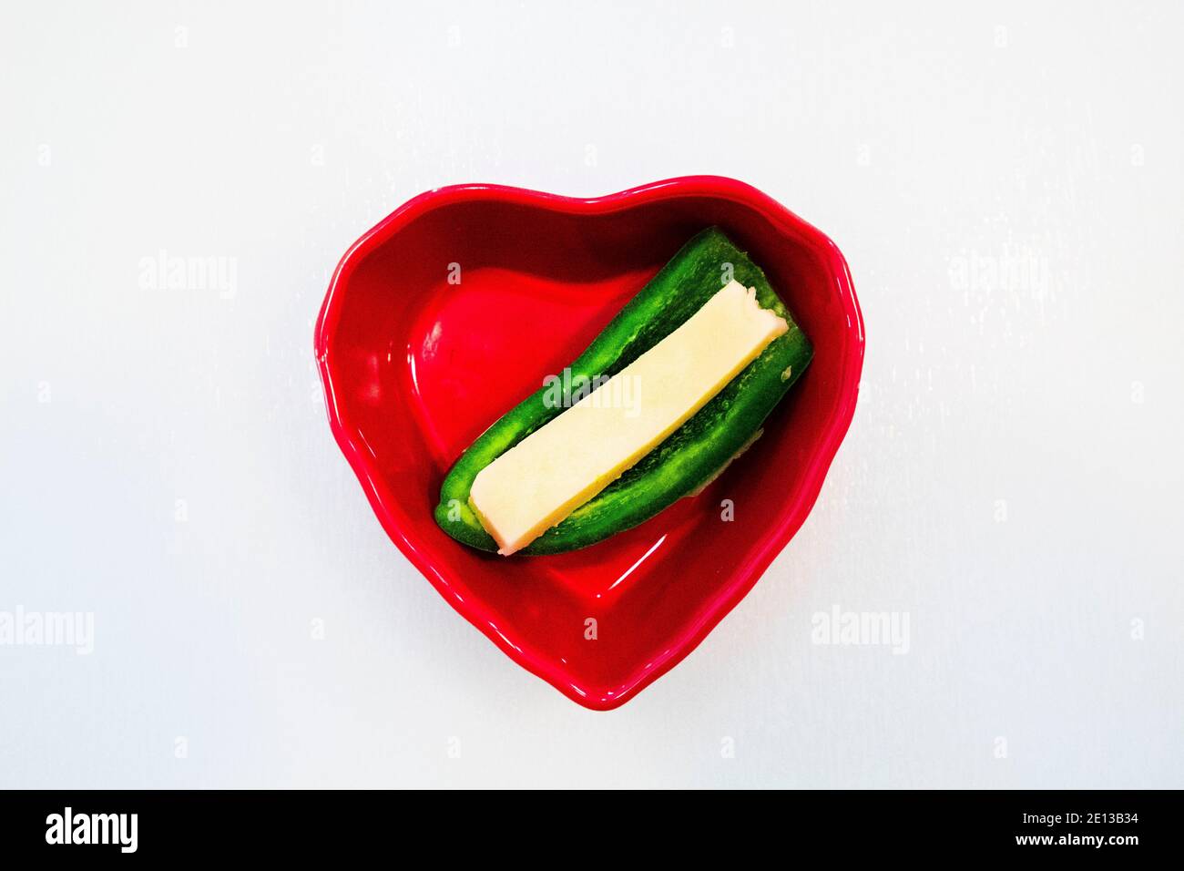 A heart for Jalapeno and cheese in a red heart dish Stock Photo - Alamy
