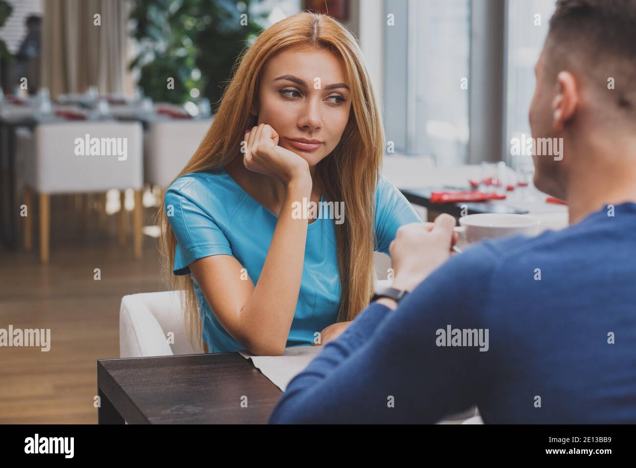 Beautiful woman looking bored at her date at the restaurant. Attractive ...