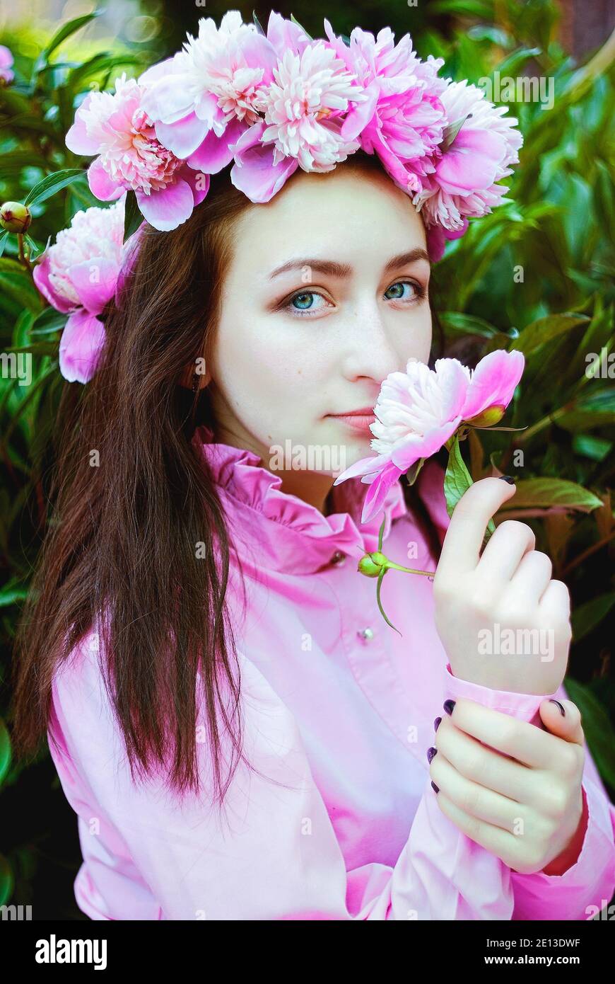 Portrait of young attractive woman in spring garden with blooming pink ...