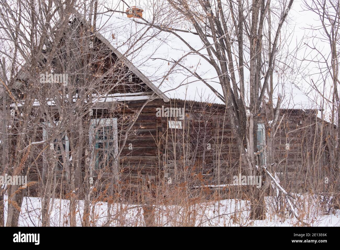Russian wooden bath in winter. The fallen white snow lies on the ground ...