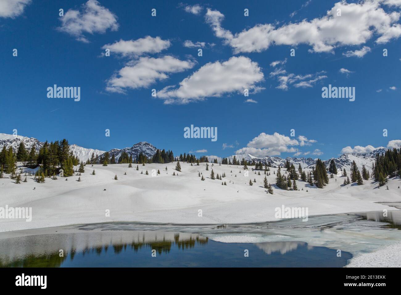 snowy spring landscape near Arosa with lake lower Praetsch, cloudy blue ...