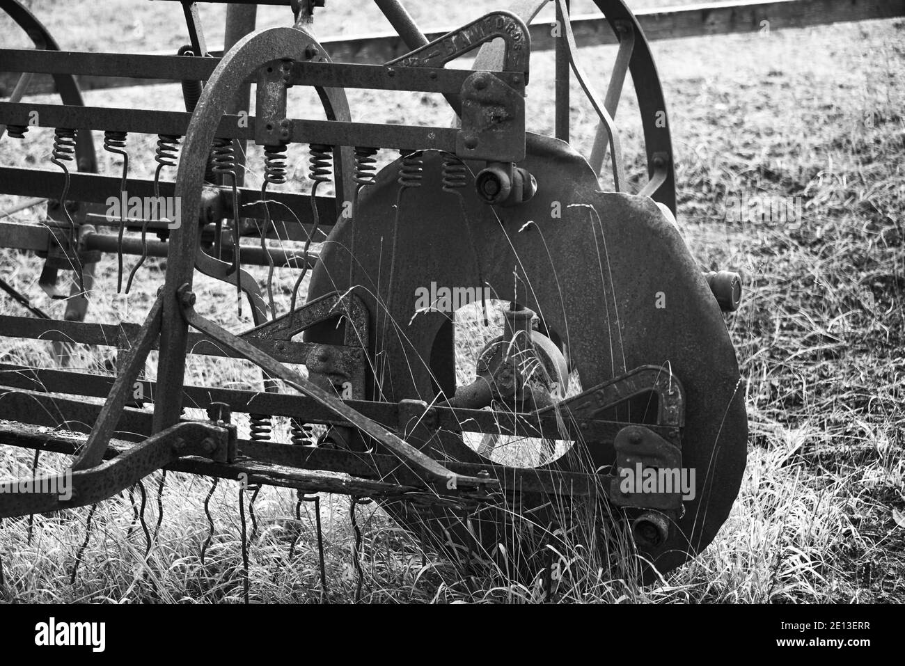 Old farming machinery in field, double action haymaker Stock Photo - Alamy