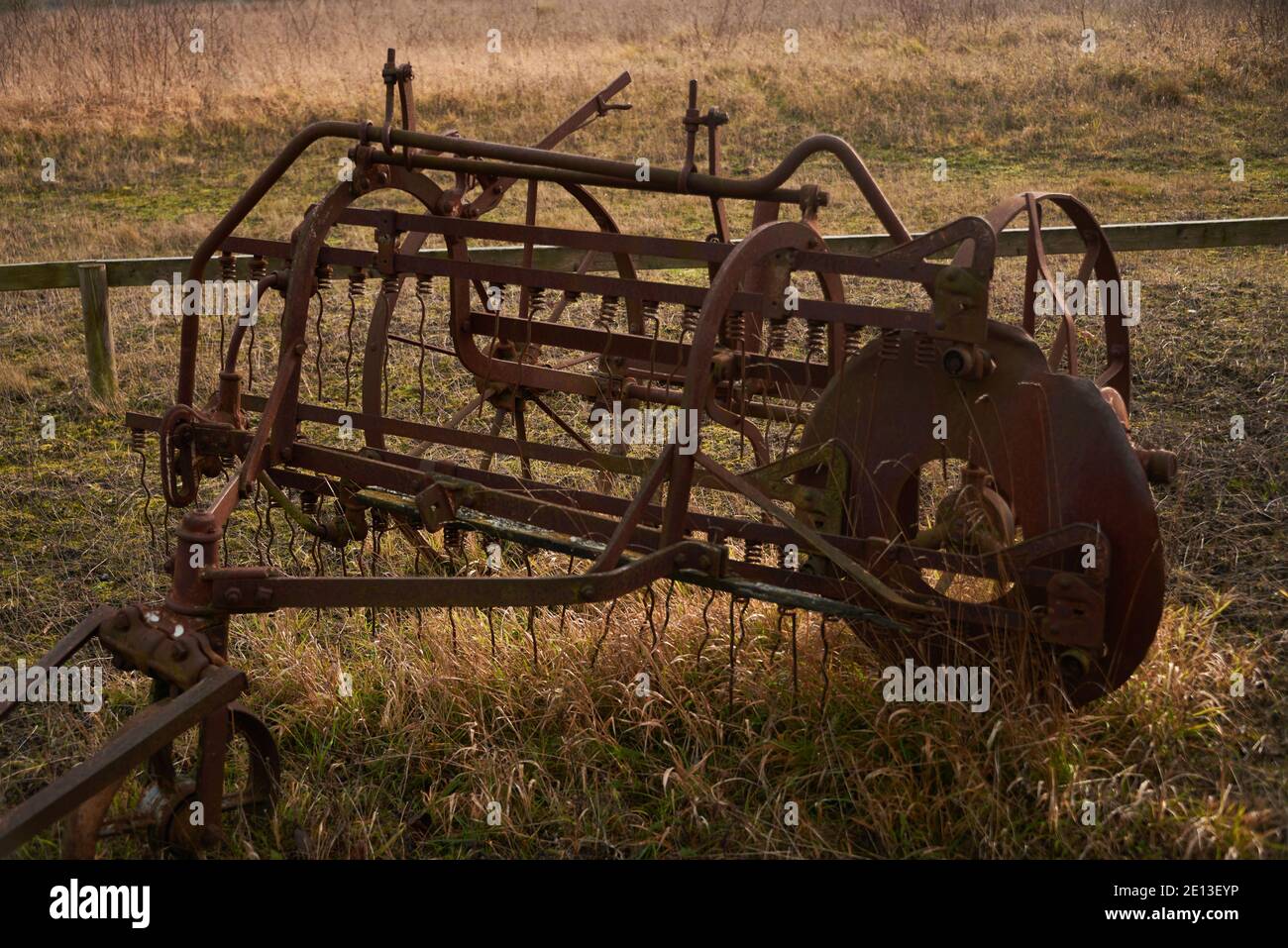 Old farming machinery in field, double action haymaker Stock Photo - Alamy