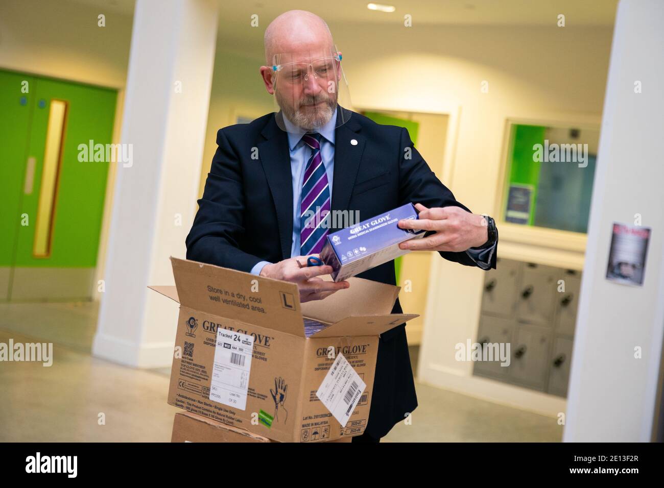 John Murphy CEO of Oasis Community Learning unboxes gloves at Oasis ...