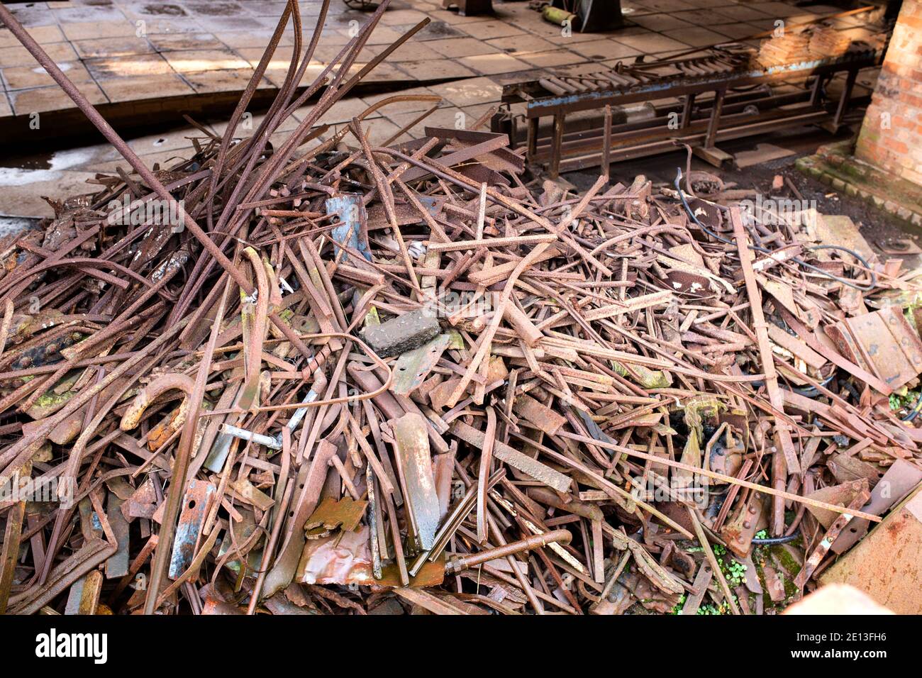 Scrap metal piled outside a factory warehouse. Recycling concept Stock ...
