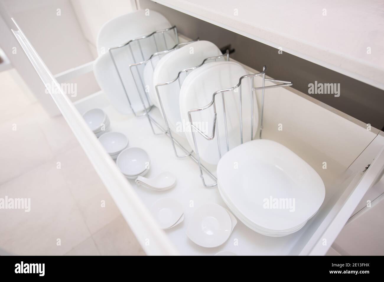 Plates in a kitchen drawer Stock Photo - Alamy