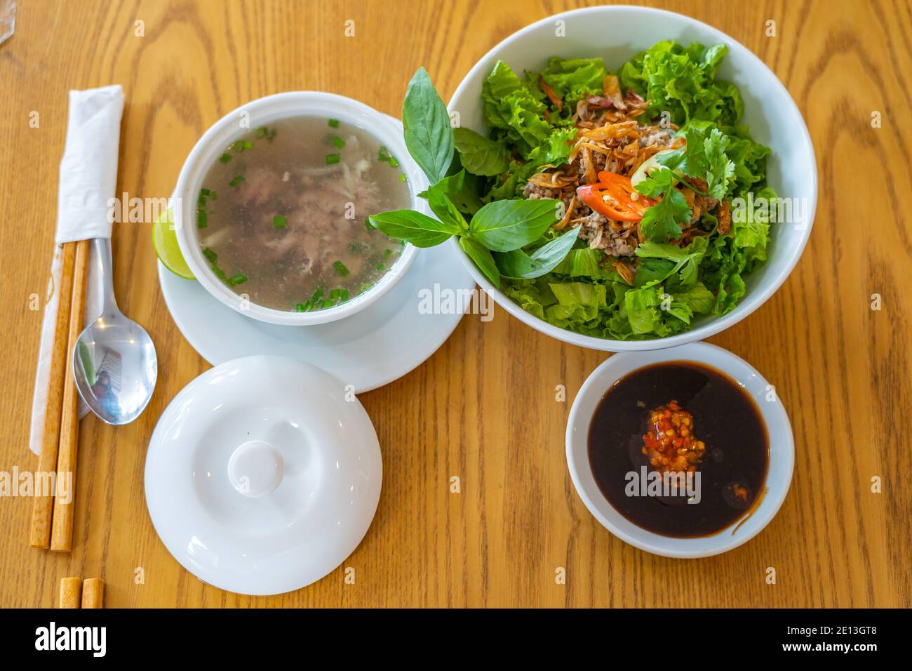 Delicious Vietnamese Pho bowl on wooden table background Stock Photo ...