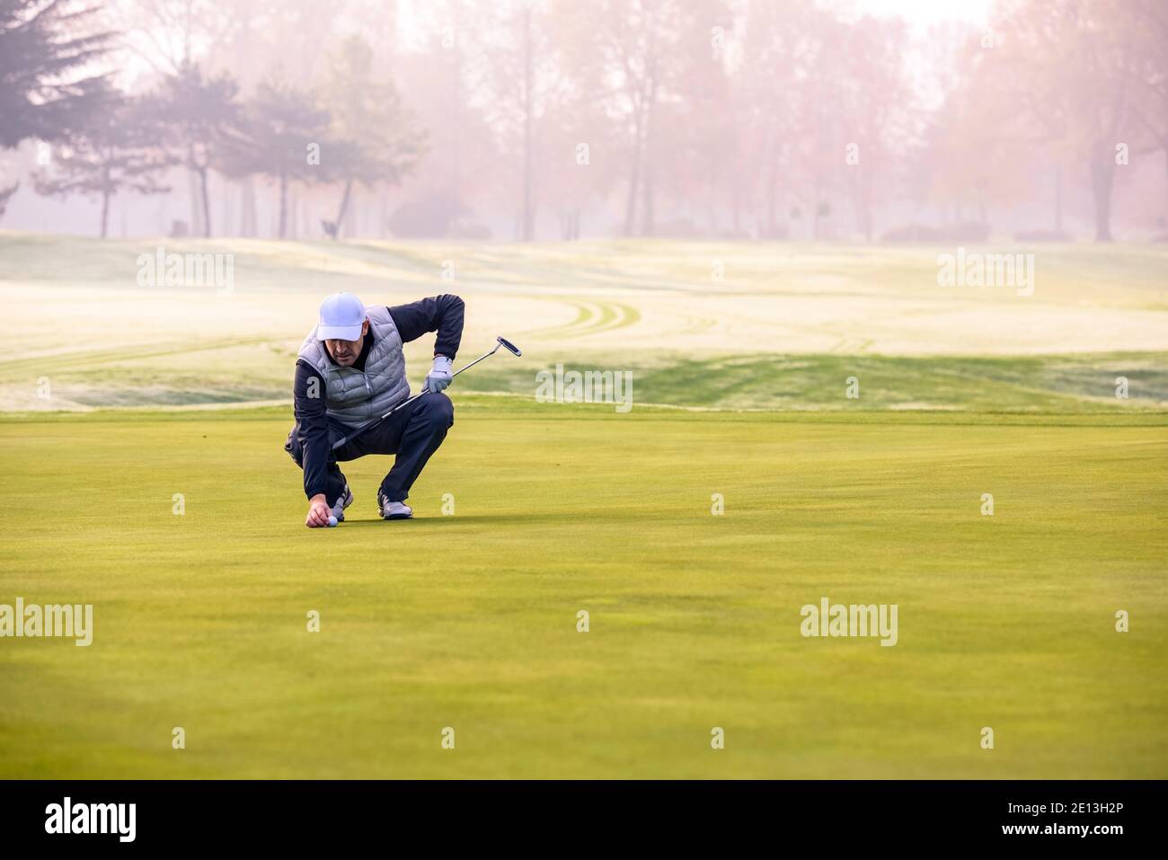 Golf player on course putting, he aiming for his put shot Stock Photo ...