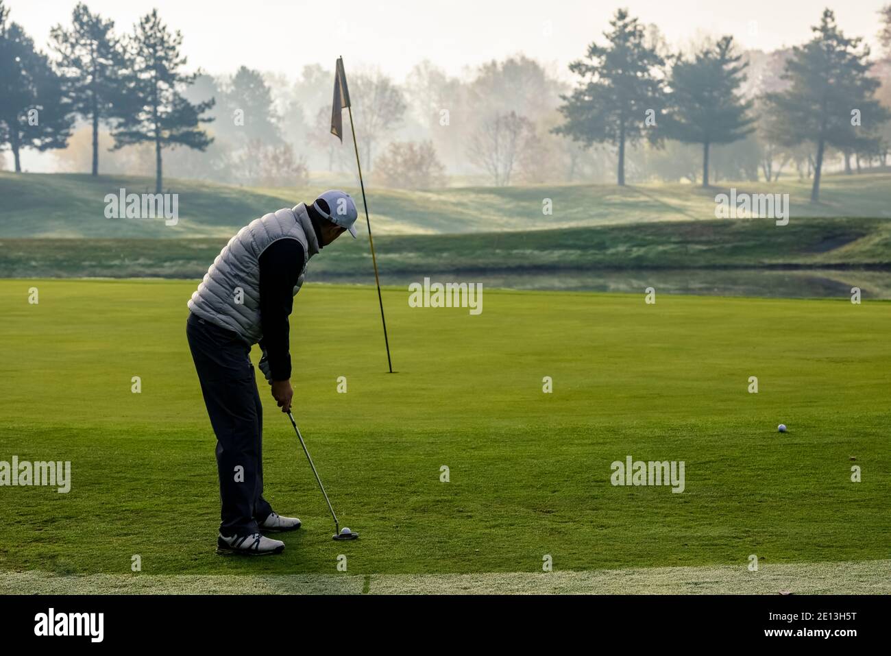 With a putt, hit the hole with the golf ball Stock Photo - Alamy