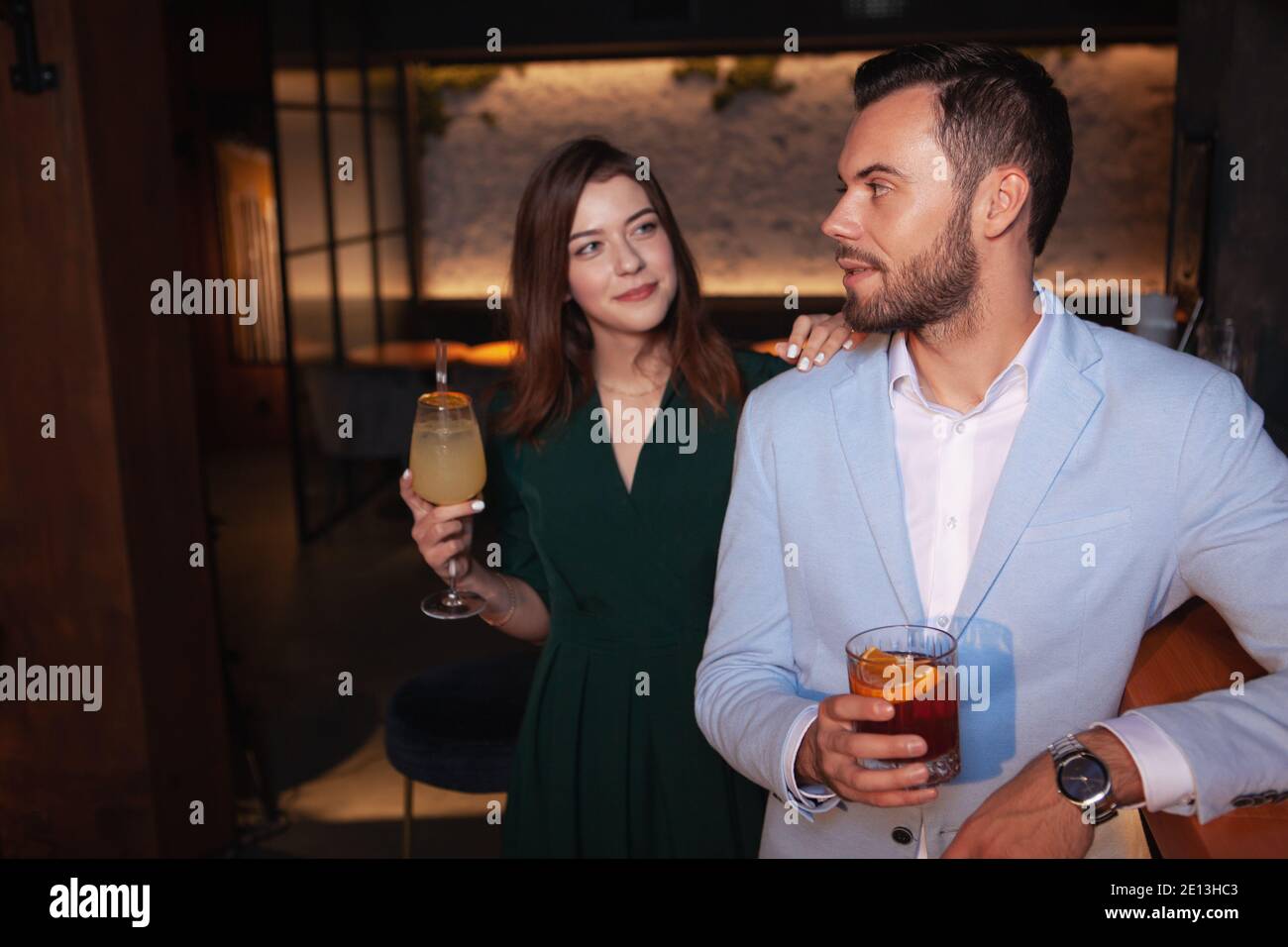 Beautiful woman approaching handsome elegant man at the bar. Young ...