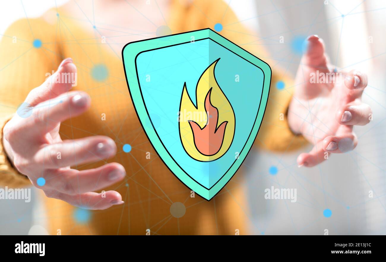 Fire protection concept between hands of a woman in background Stock ...