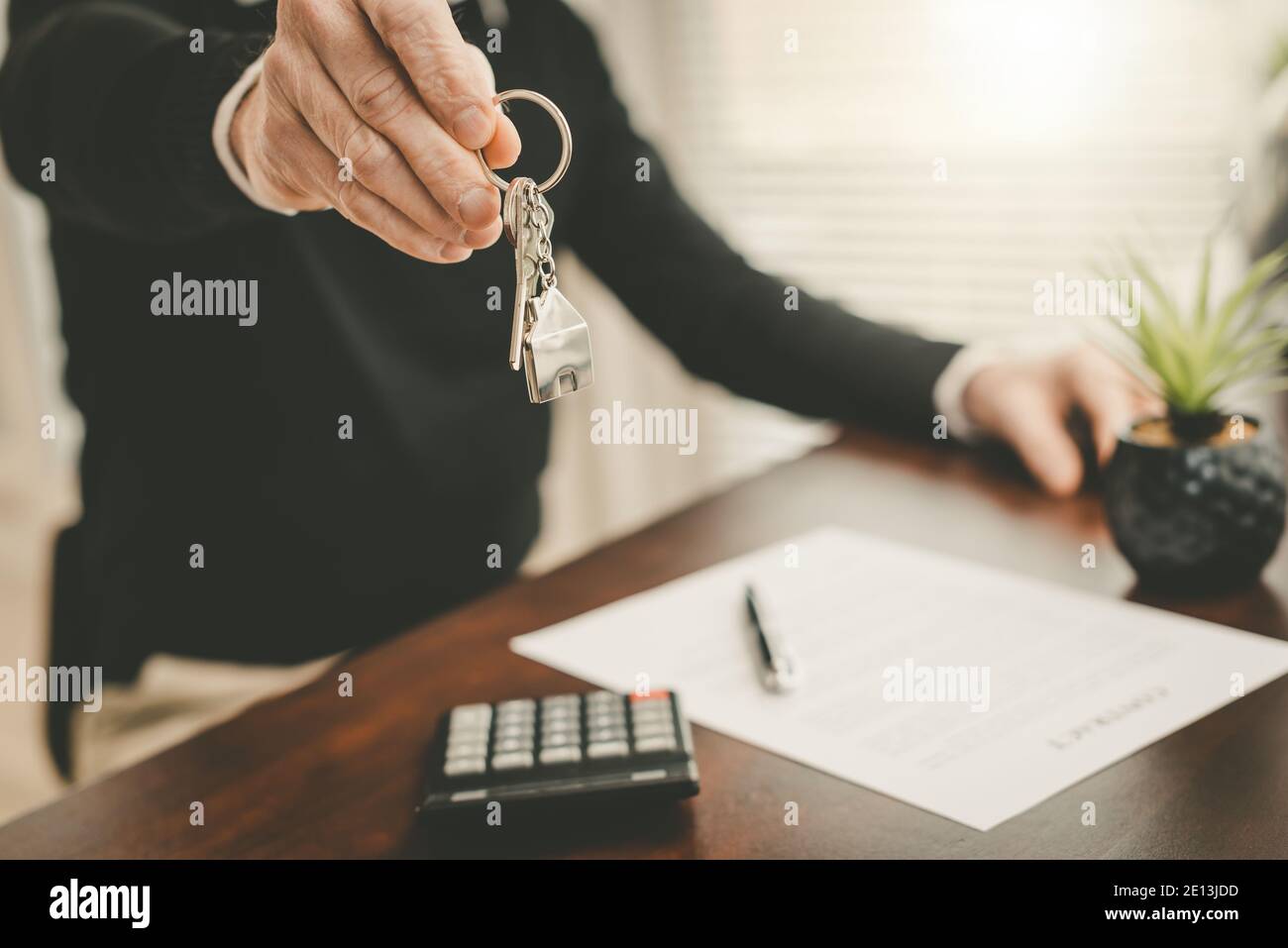 Real estate agent showing house keys after contract signing Stock Photo ...