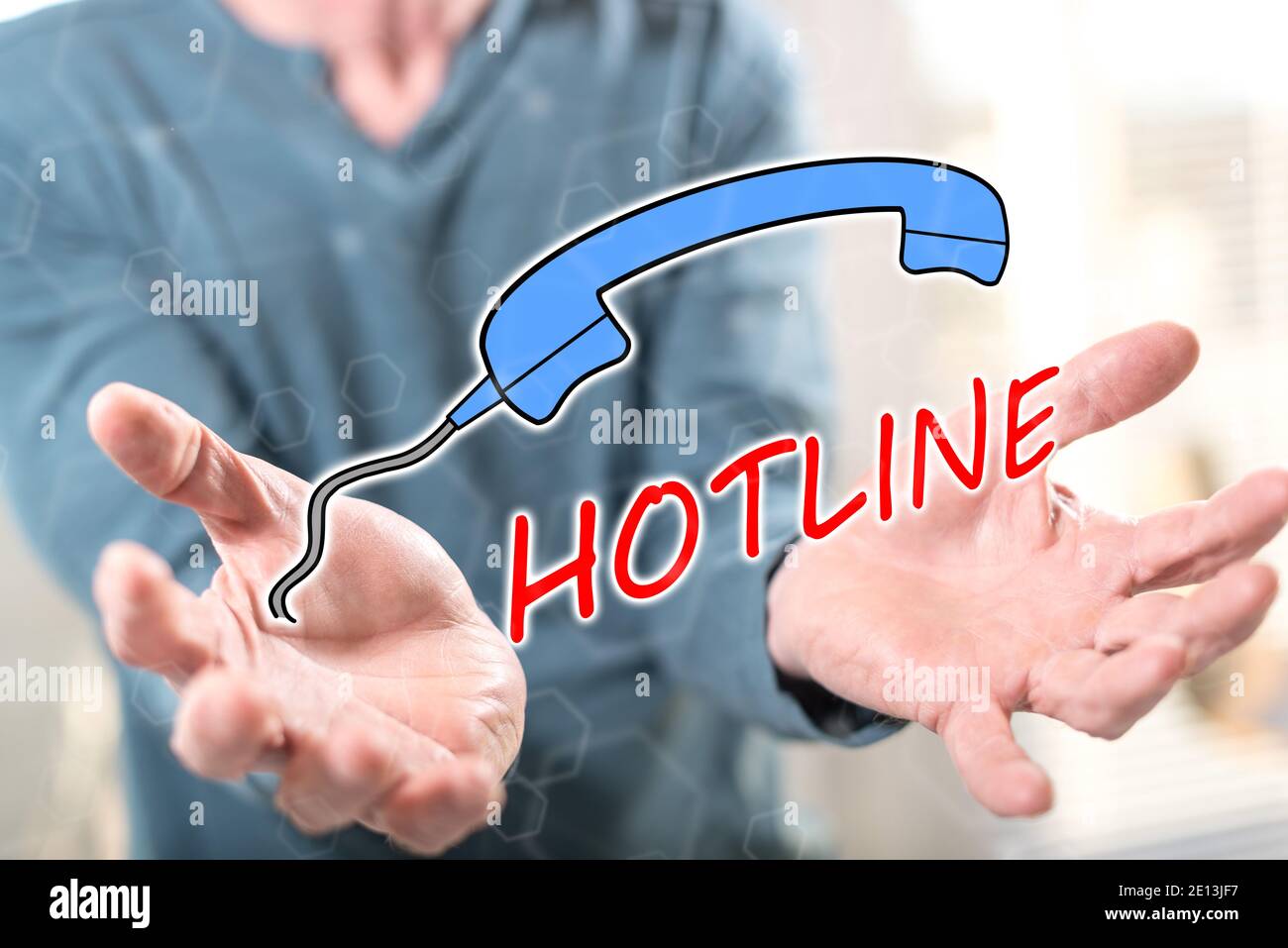 Hotline concept above the hands of a man in background Stock Photo - Alamy