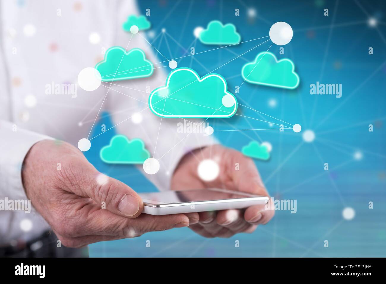 Cloud networking concept above a smartphone held by hands Stock Photo ...