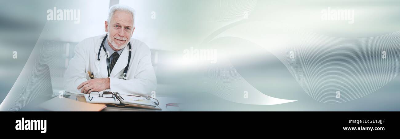 Portrait of male senior doctor sitting in medical office; panoramic ...