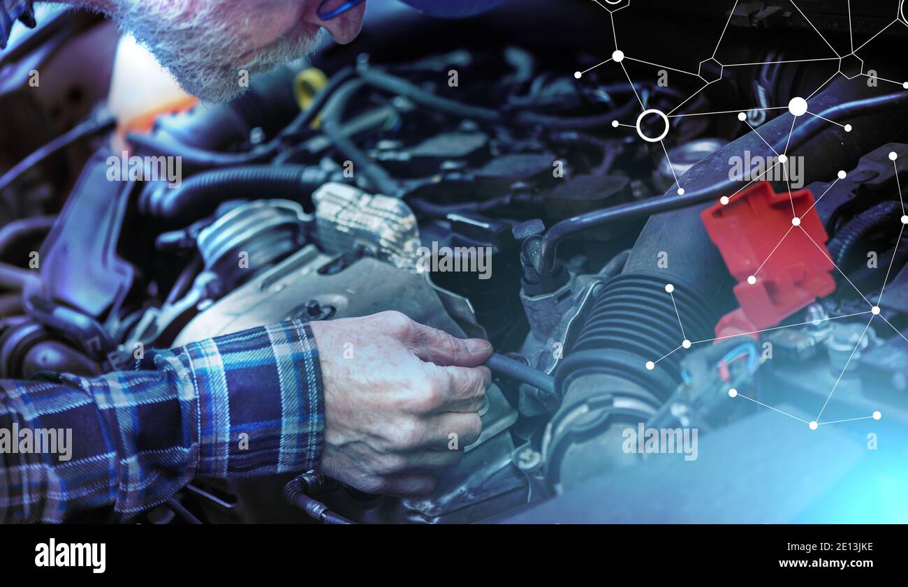 Car mechanic checking a car engine; light effect Stock Photo - Alamy