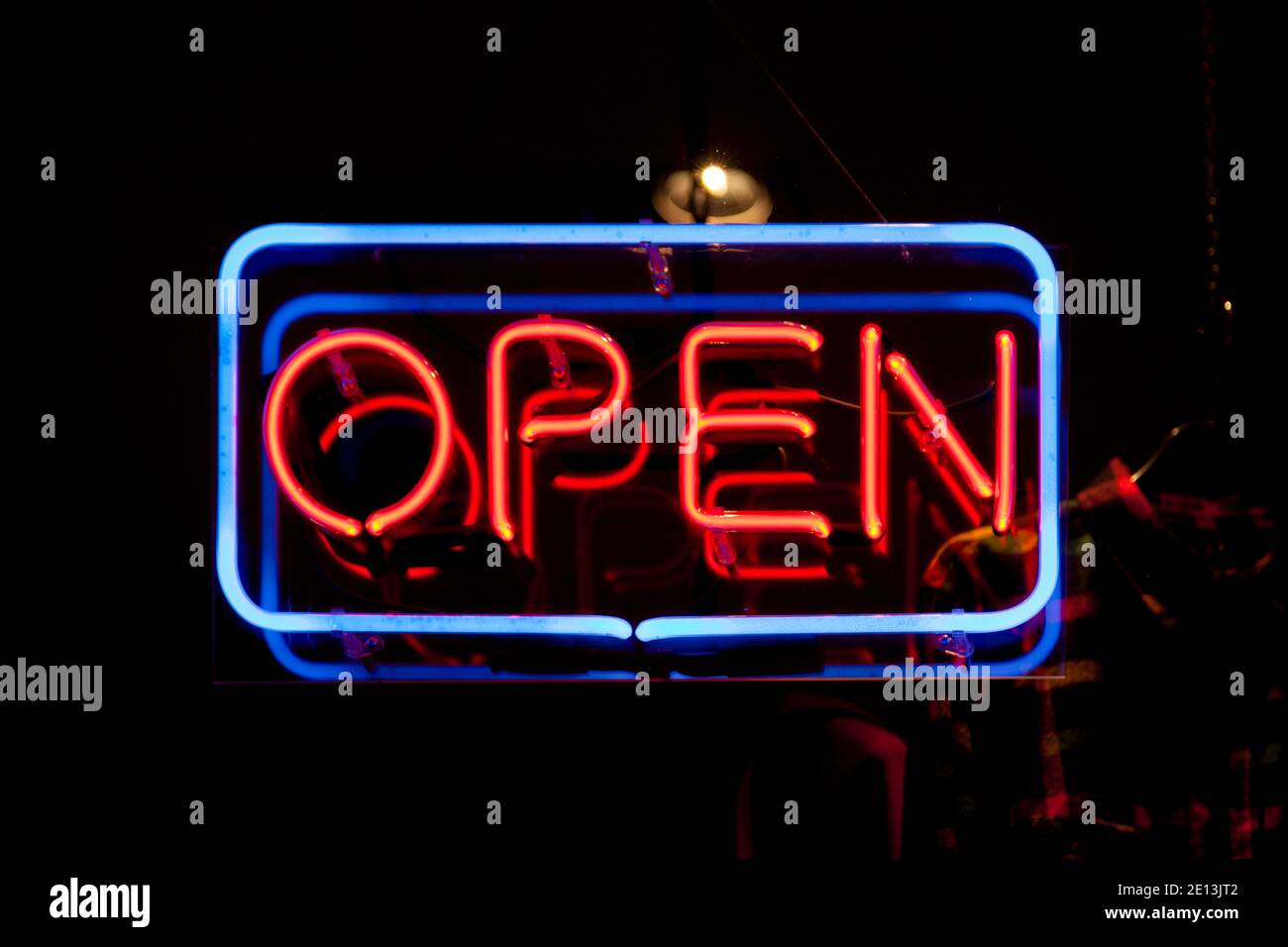 Close-up on a neon light shaped into a blue rectangle and the word ...