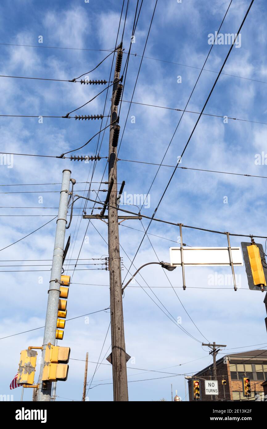 Composition of very tall power pole, traffic signals, and power lines ...