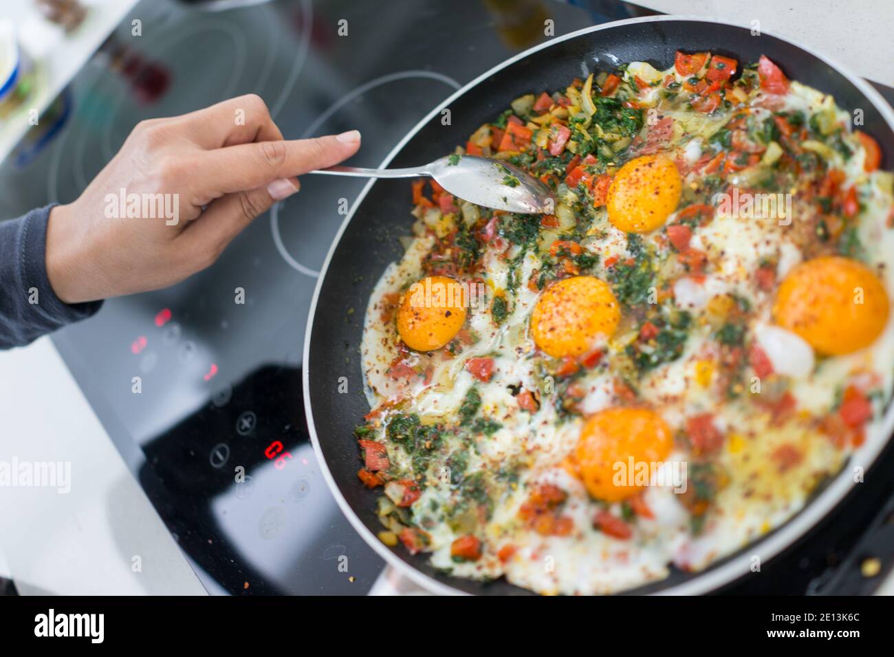 In the course of making breakfast with fresh eggs and vegetables Stock ...